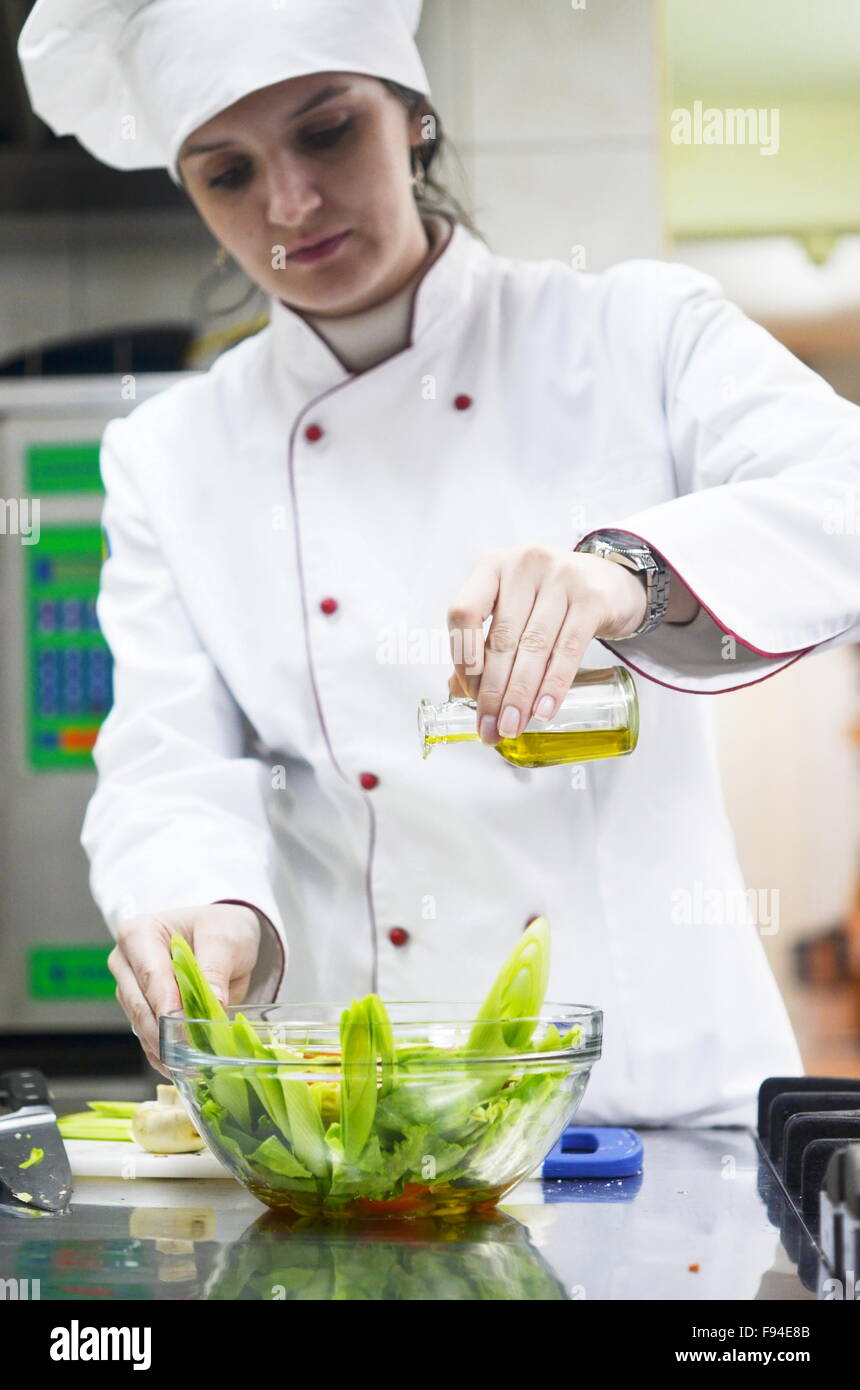 beautiful young chef woman prepare and decorating tasty food in kitchen ...