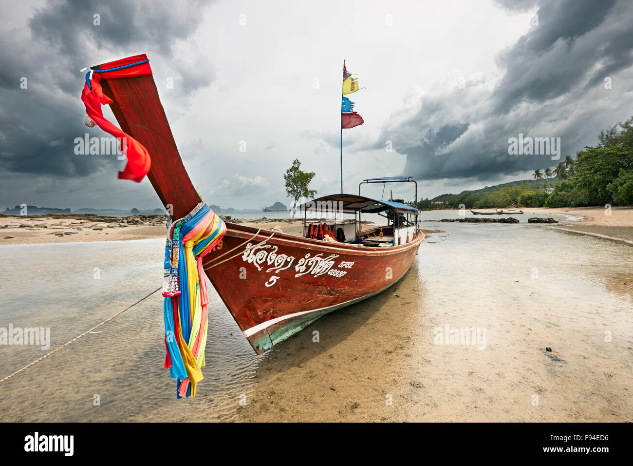 Traditional Thai longtail boat decorated with colorful ribbons on prow ...