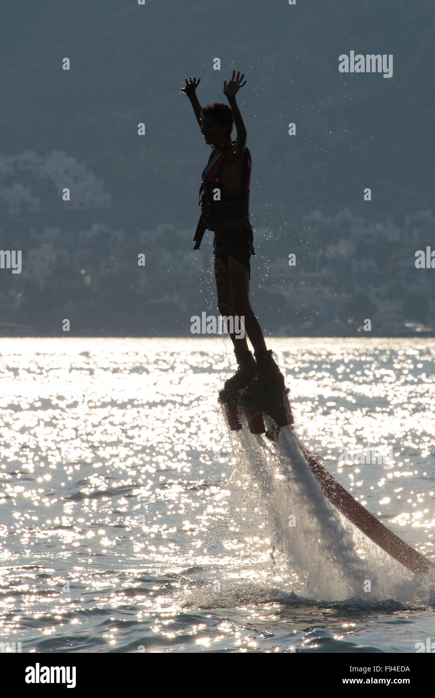 Flyboarder with both hands in the air Stock Photo - Alamy
