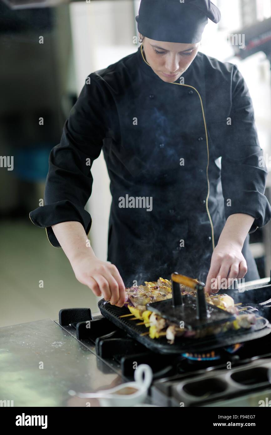beautiful young chef woman prepare and decorating tasty food in kitchen ...