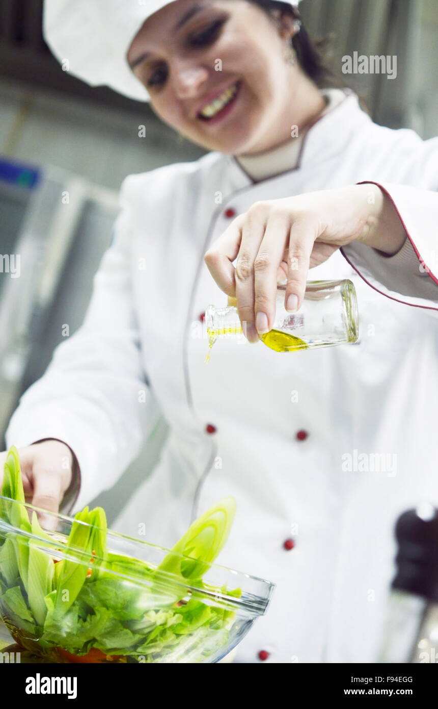 beautiful young chef woman prepare and decorating tasty food in kitchen ...