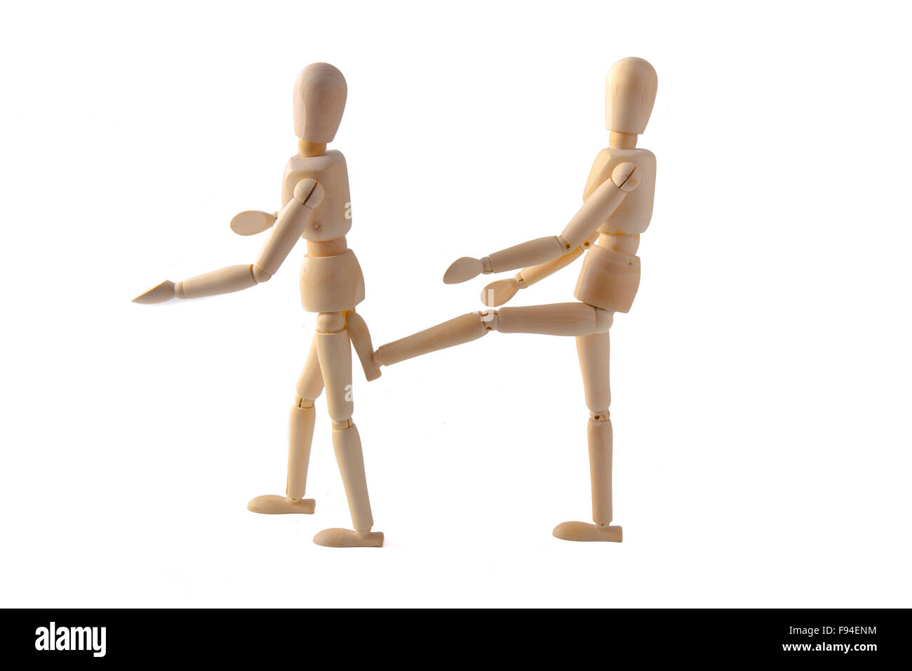 One puppet kicks another puppet on white background Stock Photo - Alamy