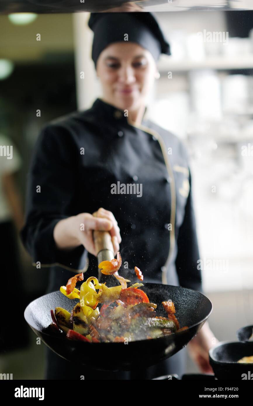 beautiful young chef woman prepare and decorating tasty food in kitchen ...