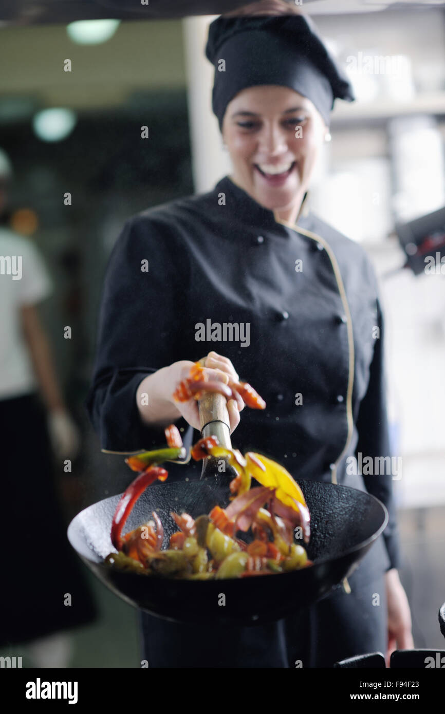 beautiful young chef woman prepare and decorating tasty food in kitchen ...