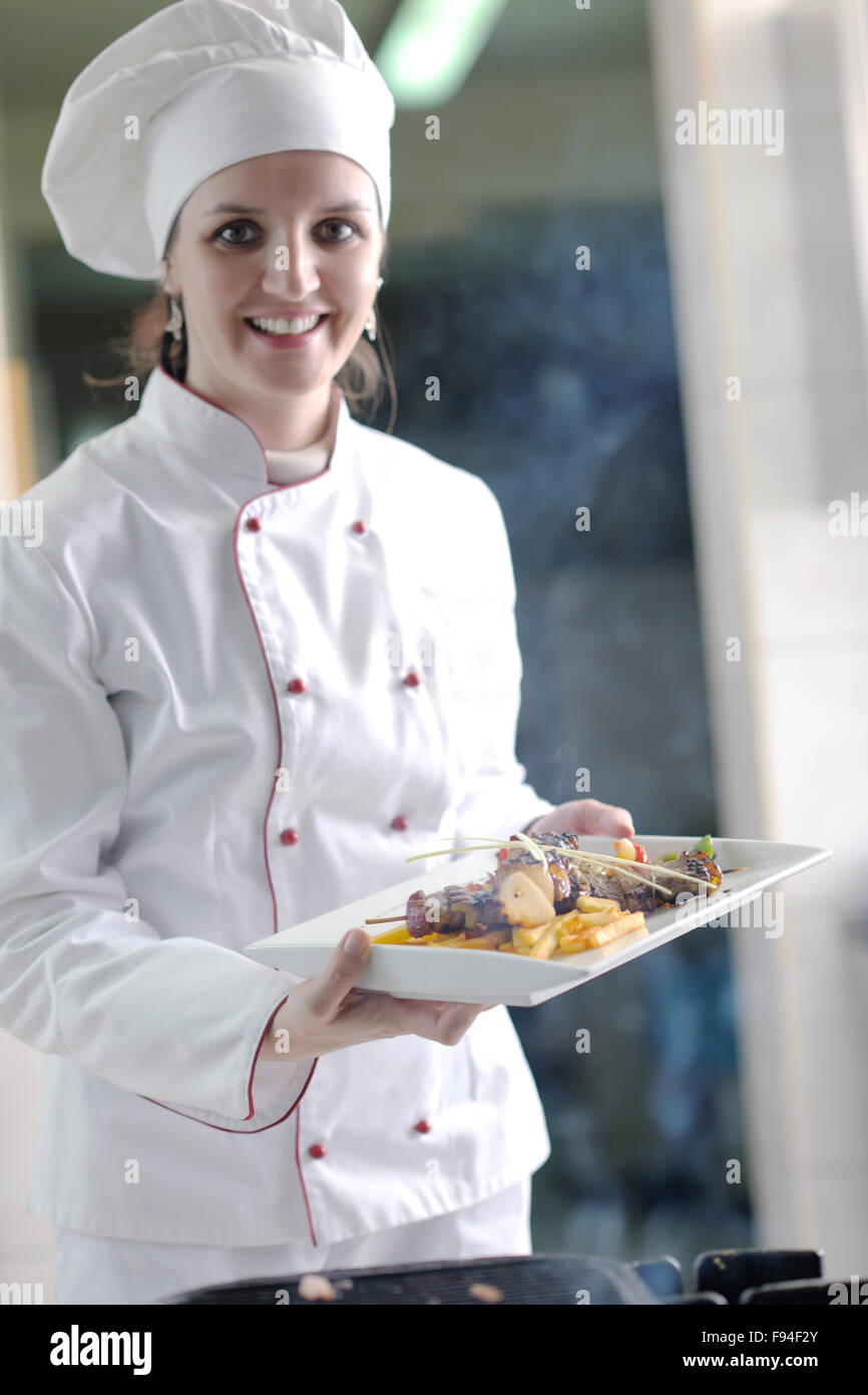 beautiful young chef woman prepare and decorating tasty food in kitchen ...
