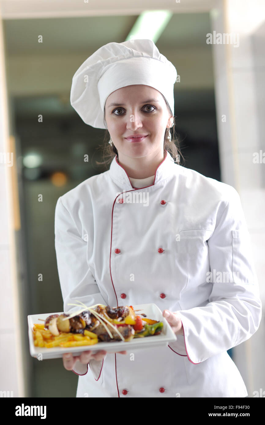 beautiful young chef woman prepare and decorating tasty food in kitchen ...