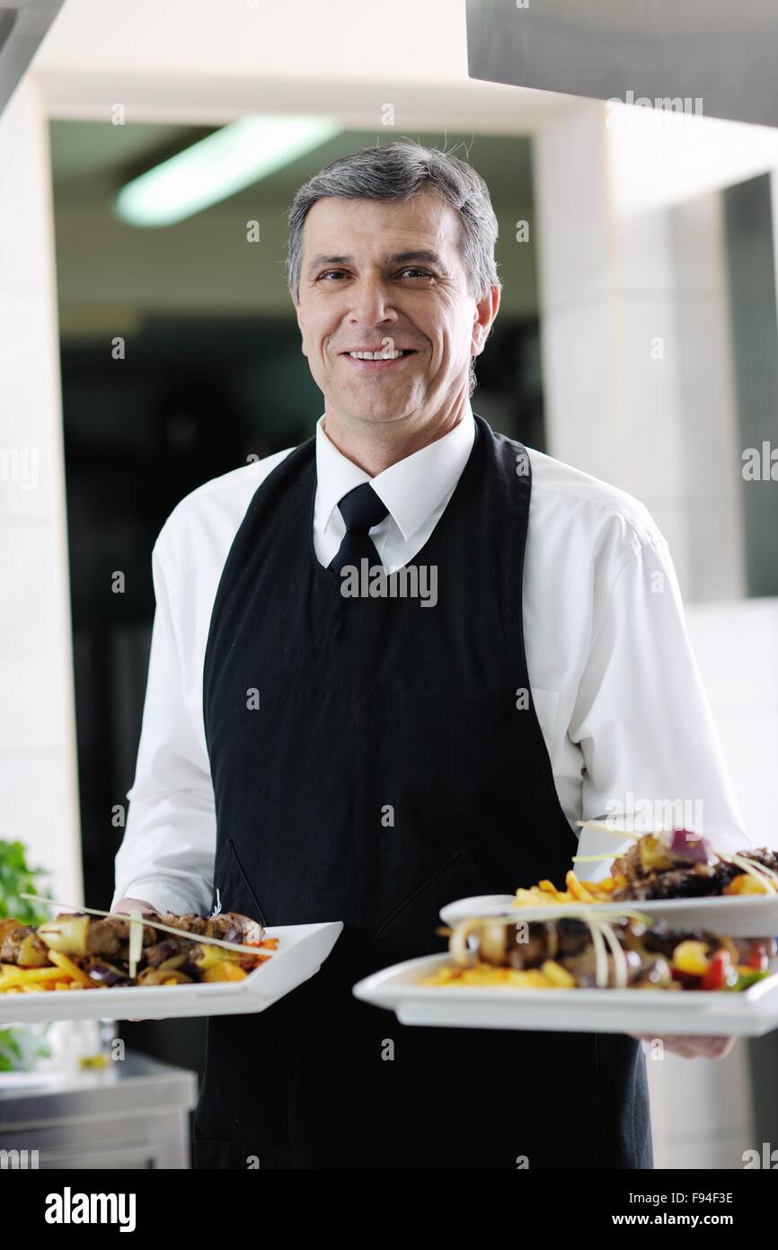 male chef presenting food meal in kitchen Stock Photo - Alamy