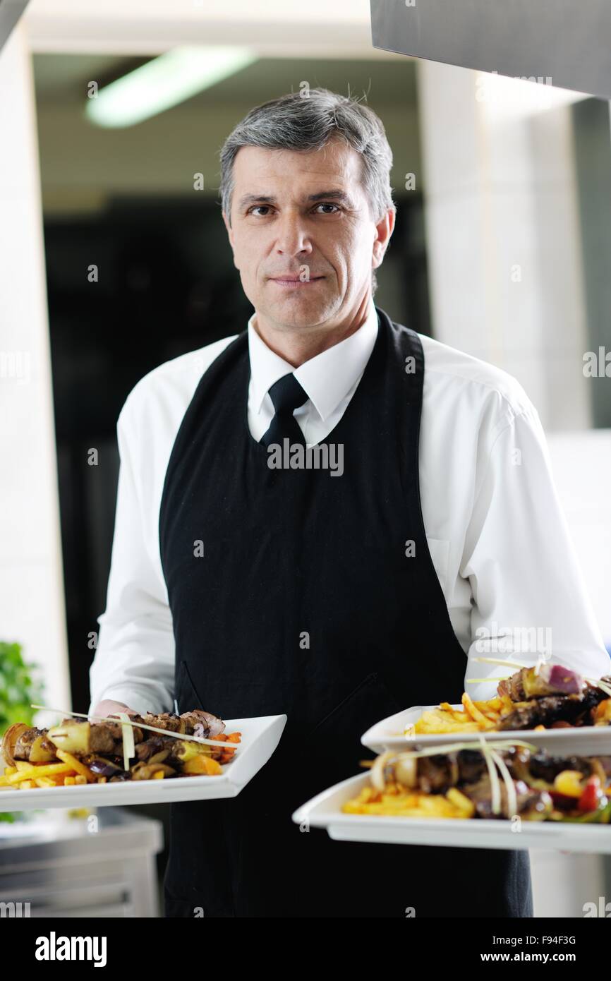 male chef presenting food meal in kitchen Stock Photo - Alamy