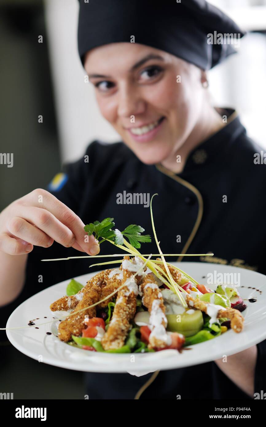 beautiful young chef woman prepare and decorating tasty food in kitchen ...