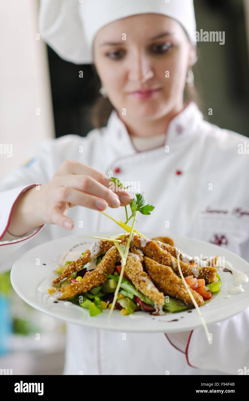 beautiful young chef woman prepare and decorating tasty food in kitchen ...