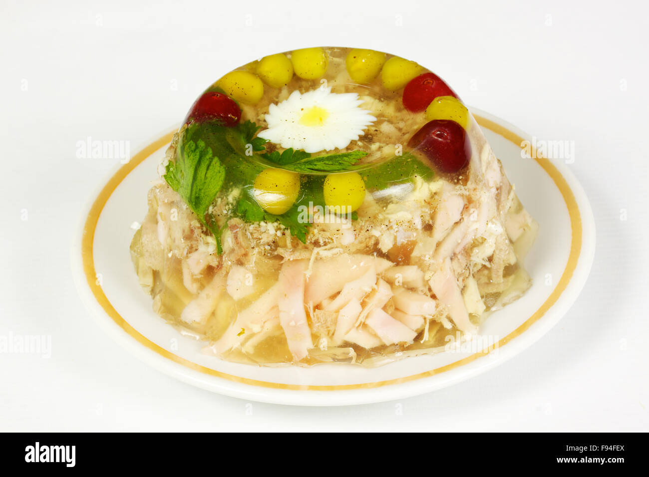 Aspic from chicken meat decorated with eggs and parsley on the white ...