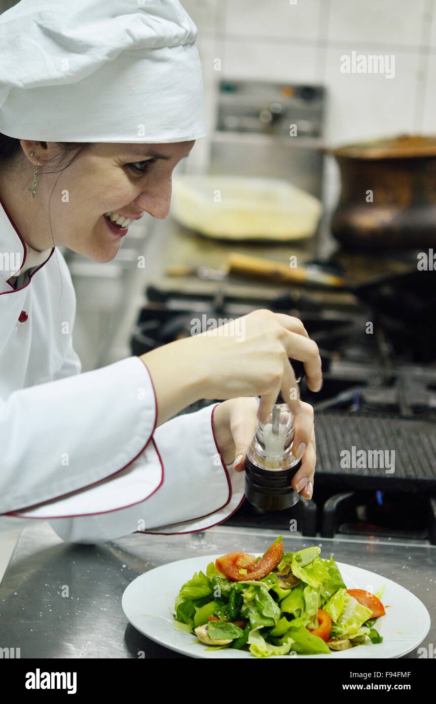 beautiful young chef woman prepare and decorating tasty food in kitchen ...