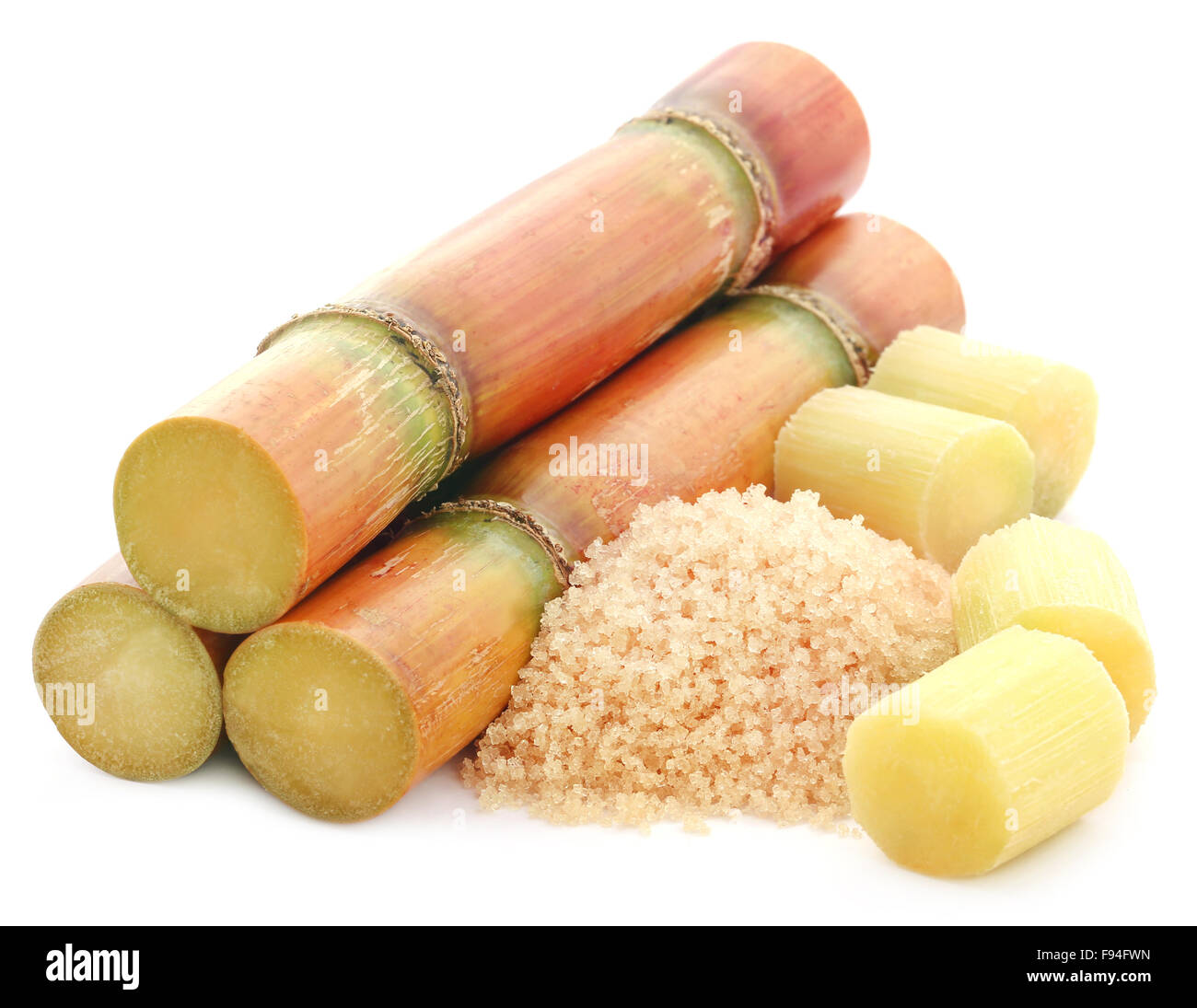 Piece of sugarcane with red sugar over white background Stock Photo - Alamy