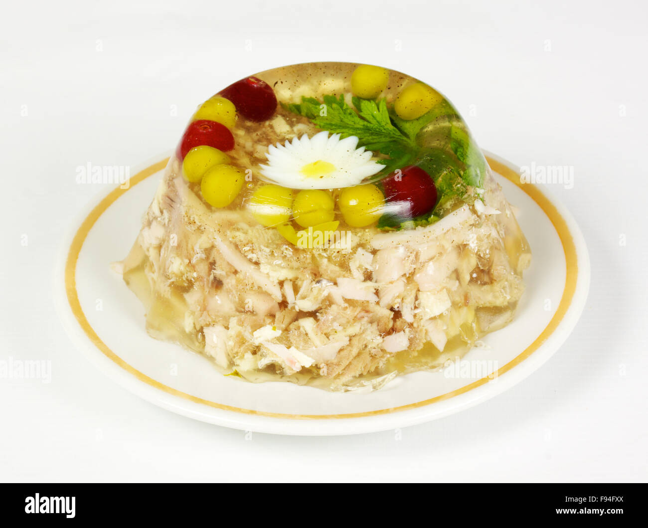 Aspic from chicken meat decorated with eggs and parsley on the white ...
