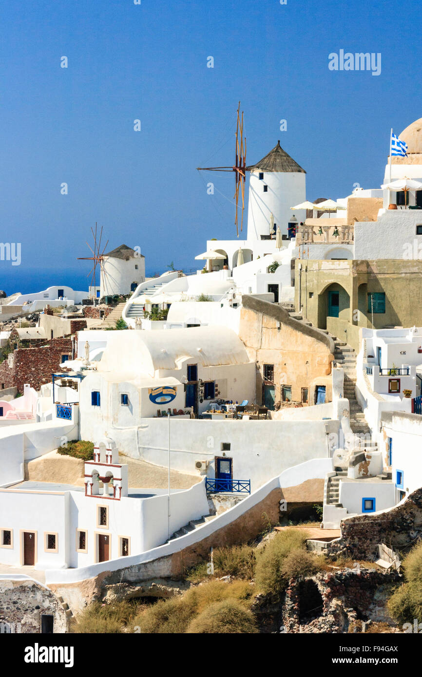 Santorini, Oia. View along town, built on sloping cliff, with ...