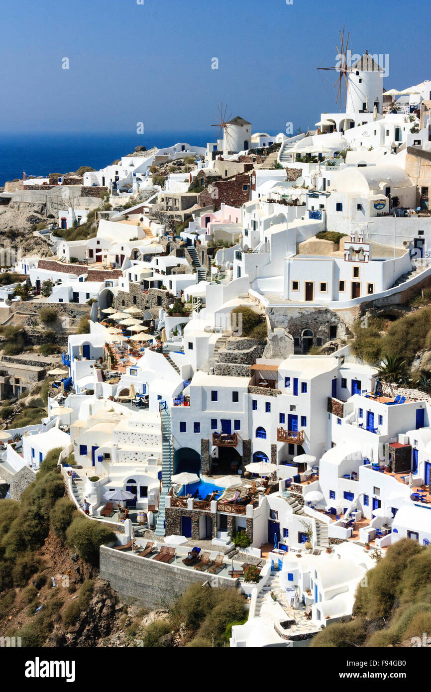 Santorini, Oia. View along town, built on sloping cliff, with ...