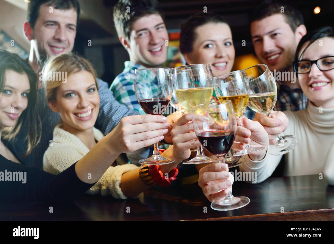 Group of happy young people drink wine at party disco restaurant Stock Photo - Alamy