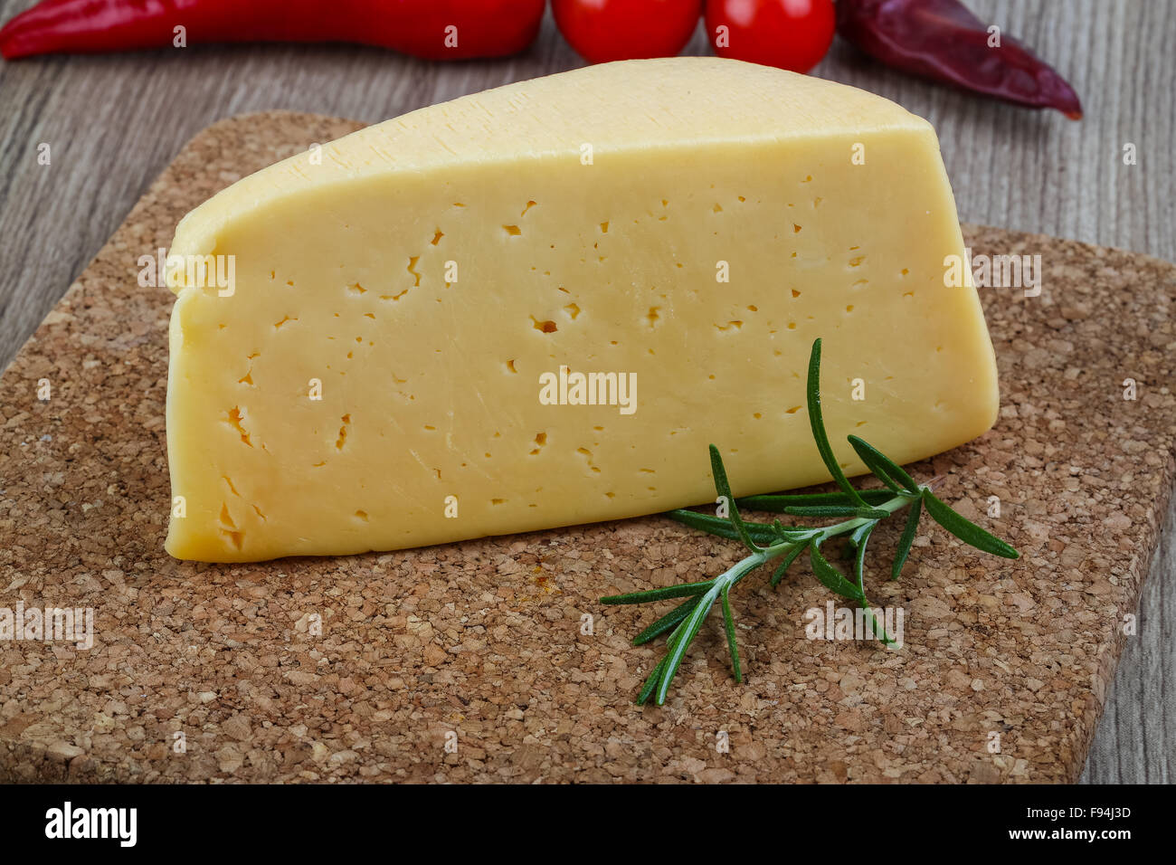 Yellow cheese triangle with rosemary herbs on the wood background Stock ...