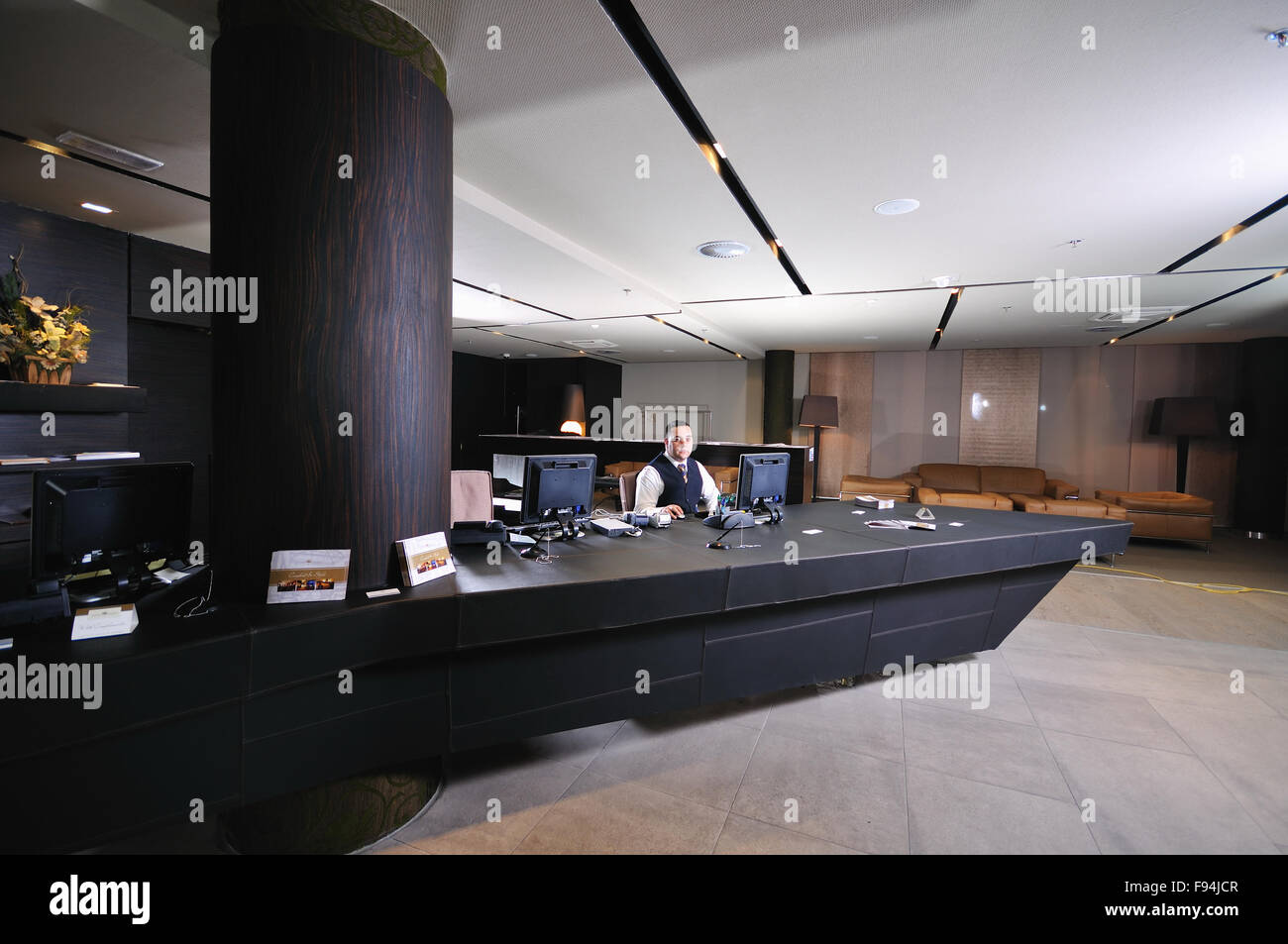 reception service man hotel indoor smile travel Stock Photo - Alamy