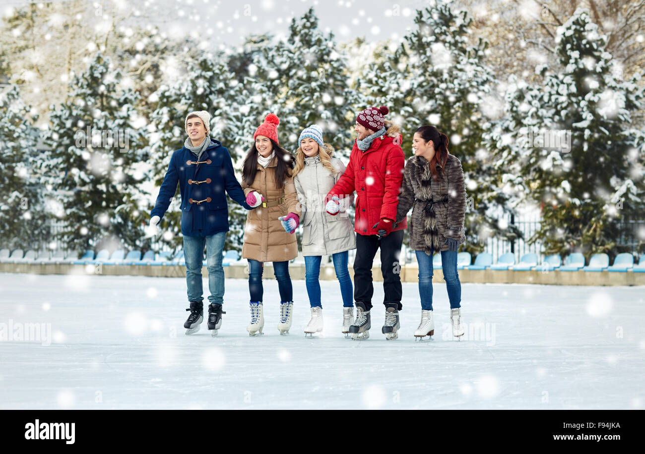 happy friends ice skating on rink outdoors Stock Photo - Alamy