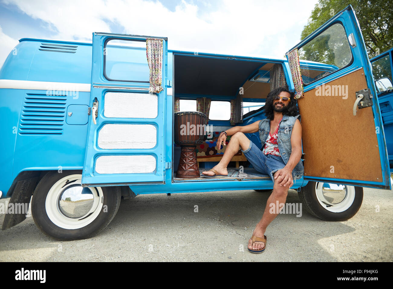 smiling young hippie man in minivan car Stock Photo - Alamy