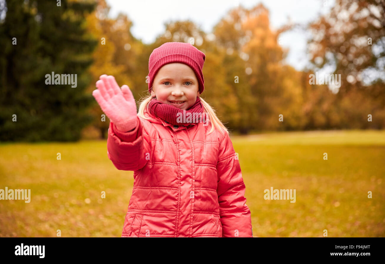 happy little girl waving hand in autumn park Stock Photo - Alamy