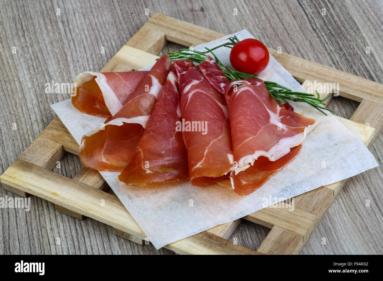 Spanish traditional snack - Jamon with tomato and rosemary Stock Photo ...