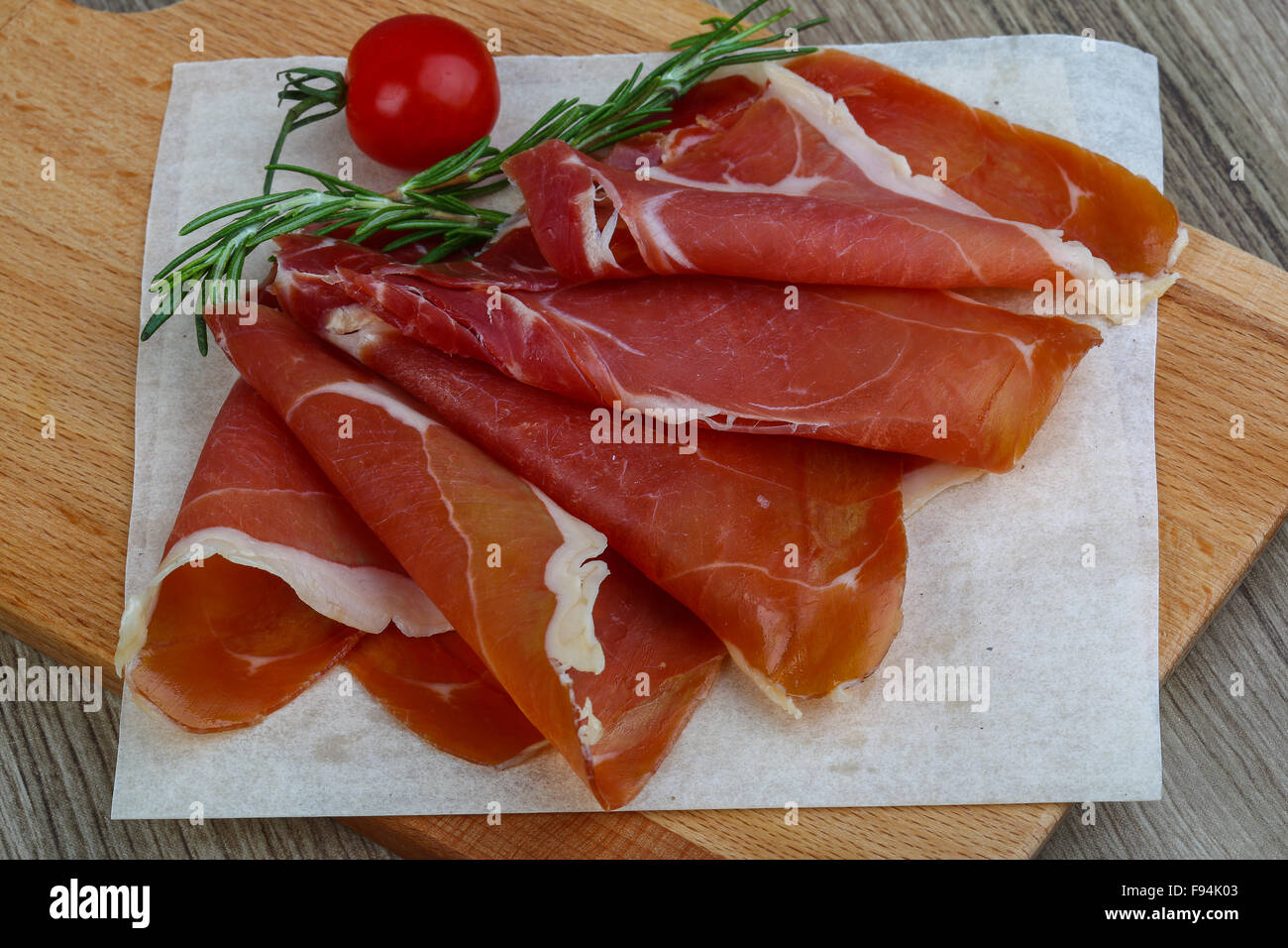 Spanish traditional snack - Jamon with tomato and rosemary Stock Photo ...