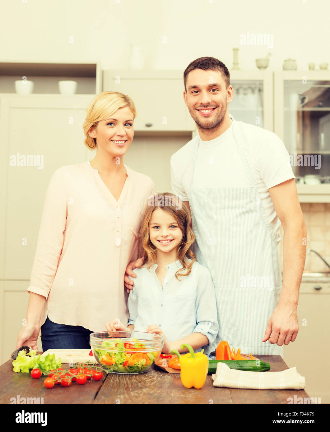 happy family making dinner in kitchen Stock Photo - Alamy