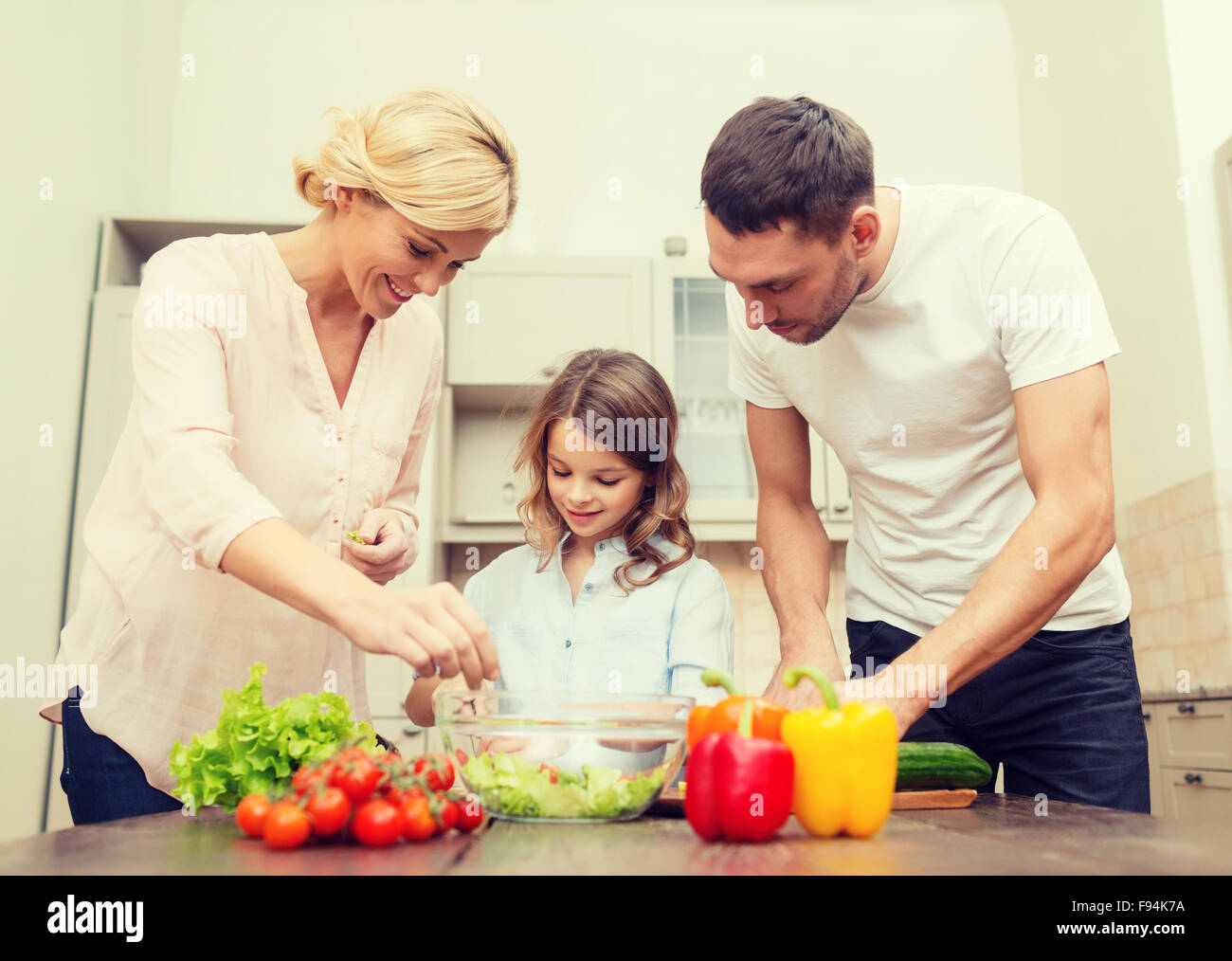 happy family making dinner in kitchen Stock Photo - Alamy