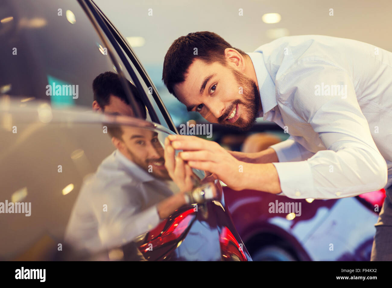 happy man touching car in auto show or salon Stock Photo - Alamy