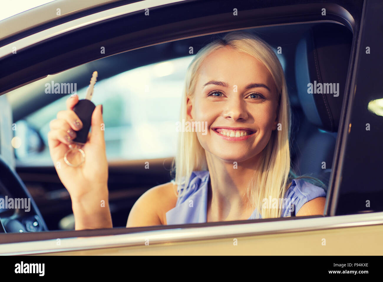 happy woman getting car key in auto show or salon Stock Photo - Alamy