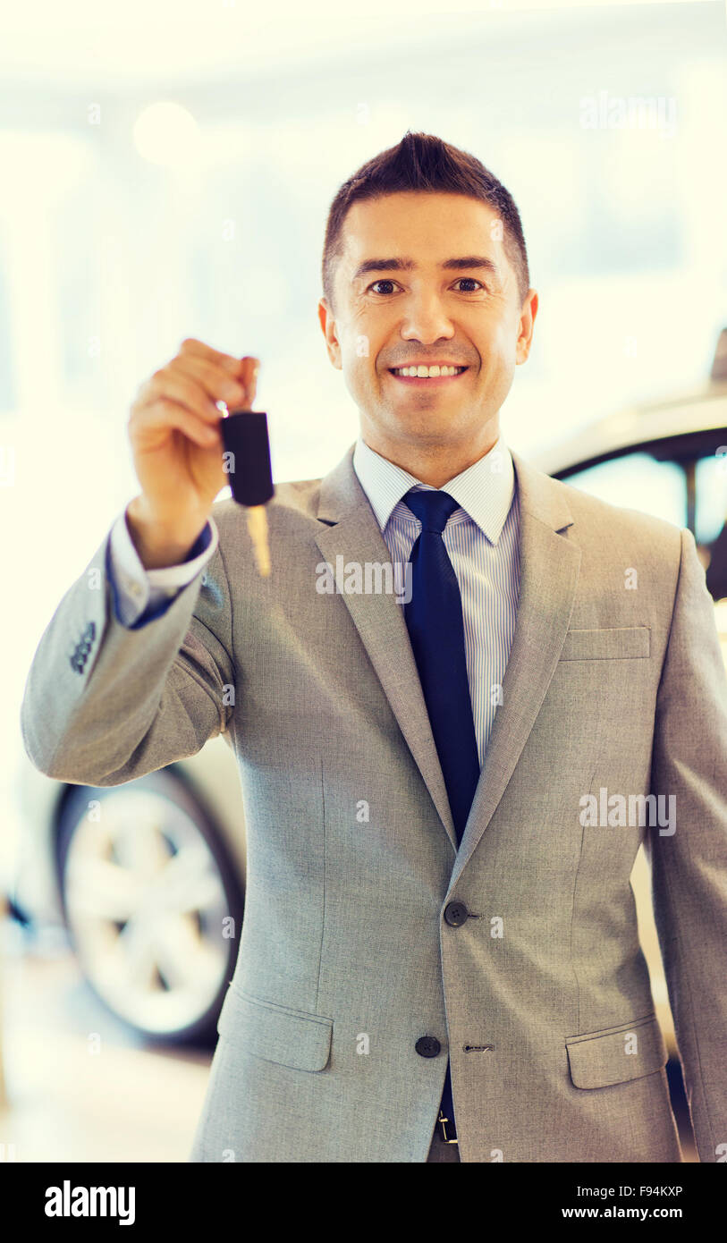 happy man showing key at auto show or car salon Stock Photo - Alamy