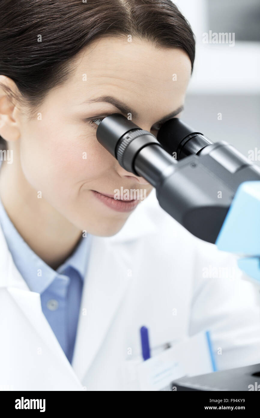 Woman looking into microscope eyepiece hi-res stock photography and ...