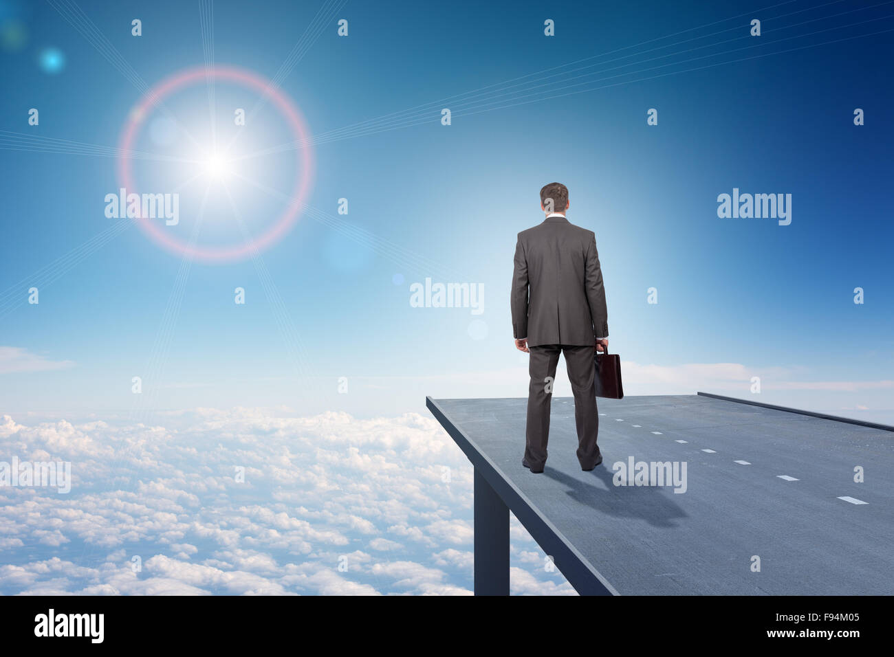 Businessman on road in sky, rear view Stock Photo - Alamy