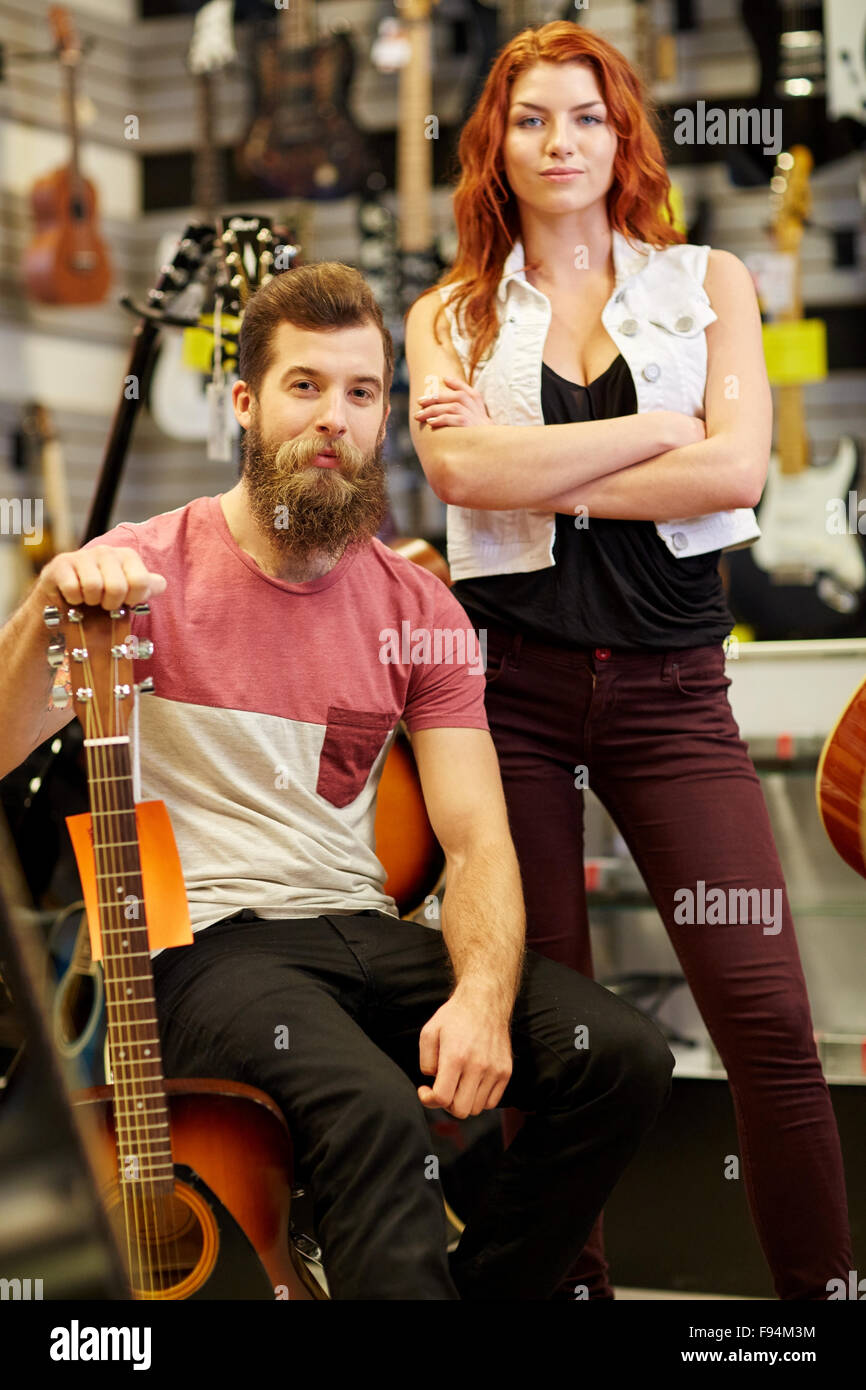 couple of musicians with guitar at music store Stock Photo - Alamy