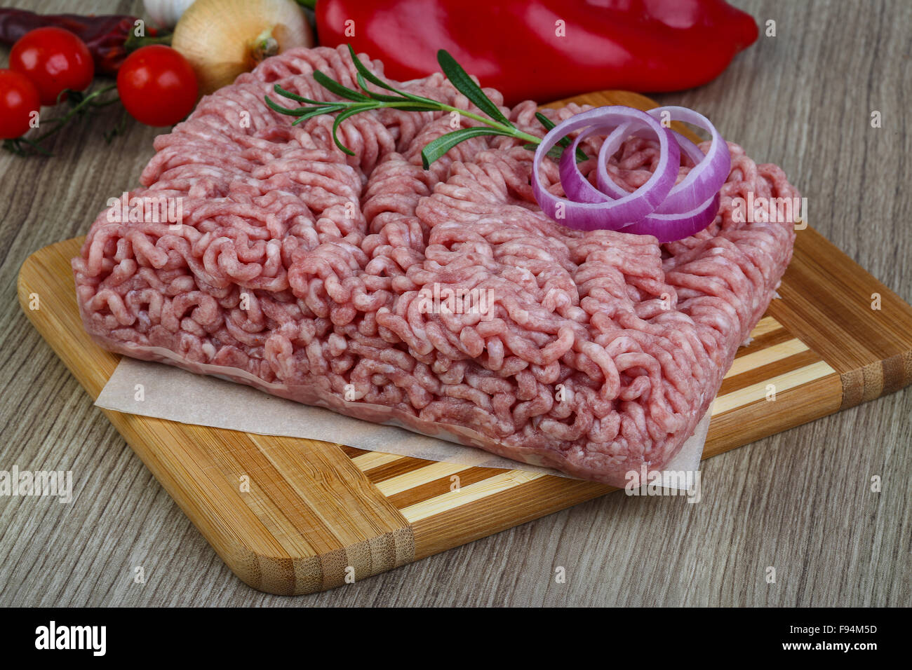 Raw minced pork meat with onion and rosemary ready for cooking Stock ...