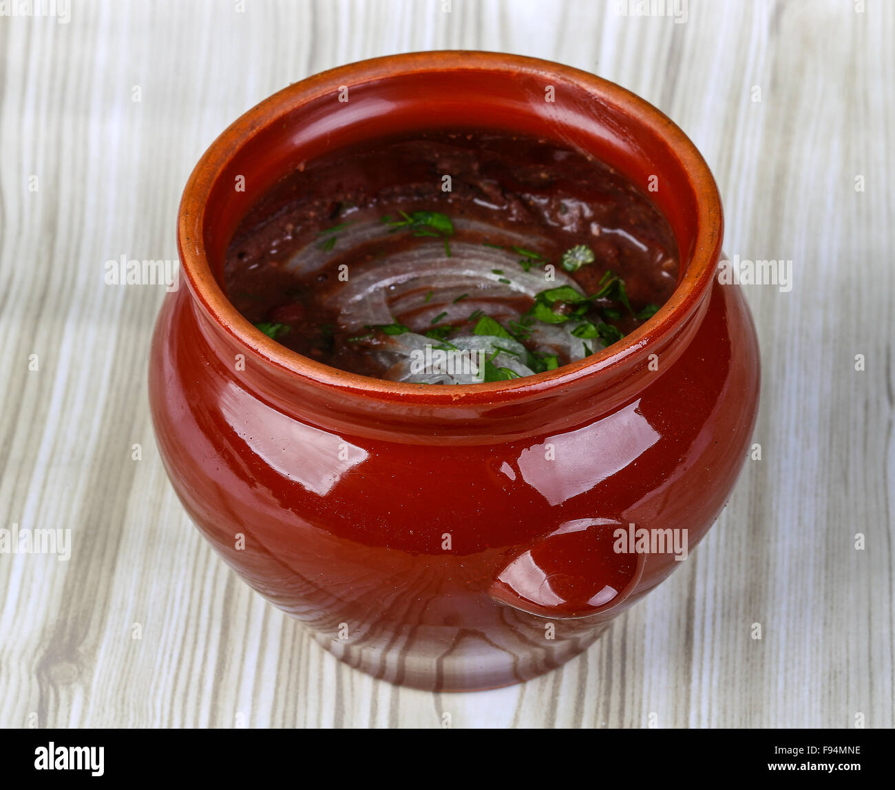 Georgian cuisine - Lobio with onion rings and fresh herbs Stock Photo ...