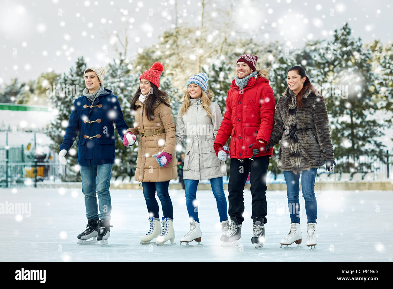 happy friends ice skating on rink outdoors Stock Photo - Alamy