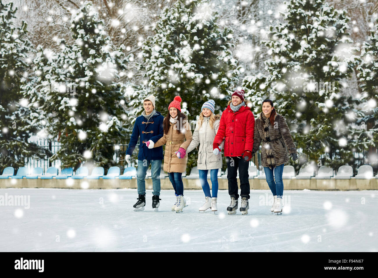 happy friends ice skating on rink outdoors Stock Photo - Alamy