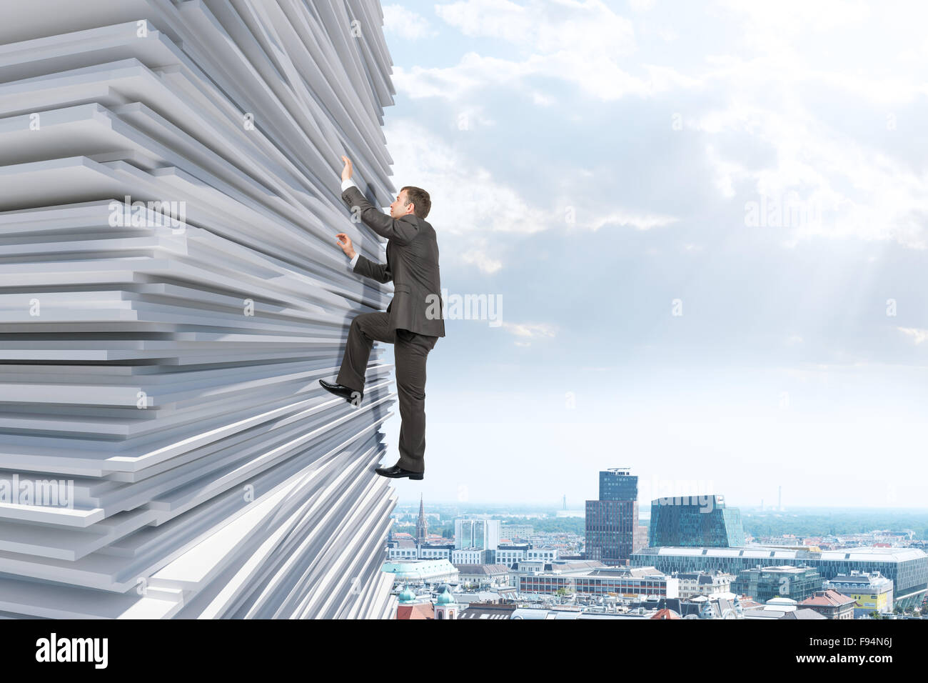 Businessman climbing up a huge stack of paper Stock Photo - Alamy