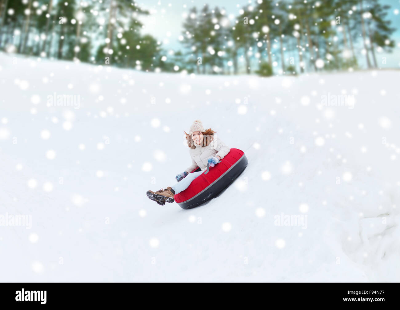 happy teenage girl sliding down on snow tube Stock Photo - Alamy
