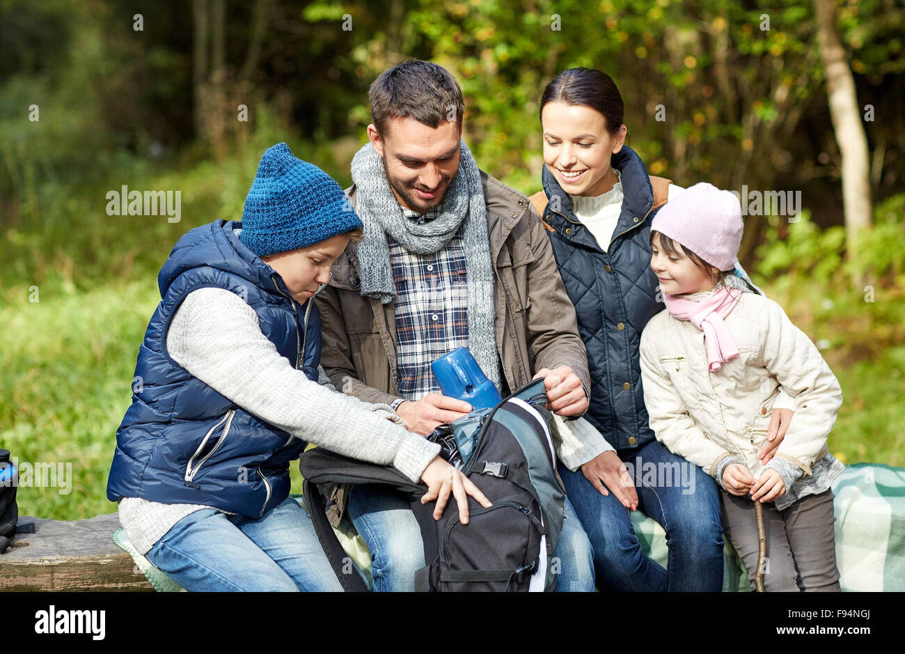 happy family with backpack and thermos at camp Stock Photo - Alamy