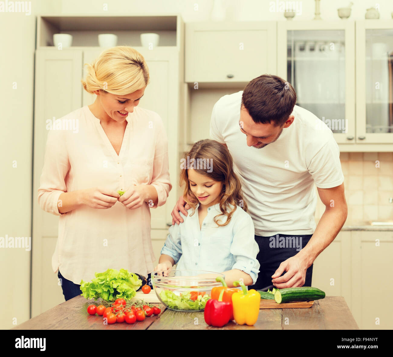 happy family making dinner in kitchen Stock Photo - Alamy