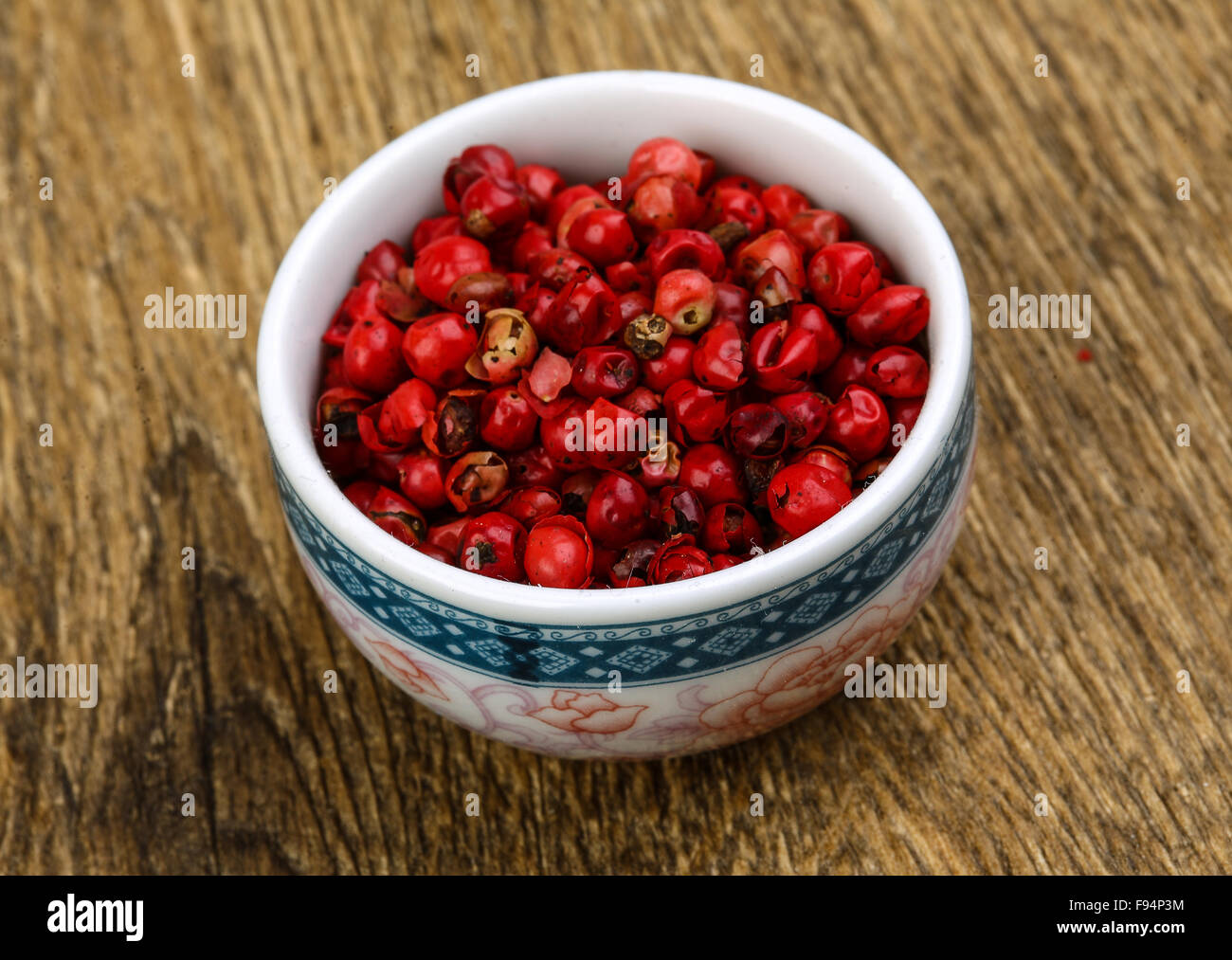 Dry Rose pepper corn on the wood background Stock Photo - Alamy