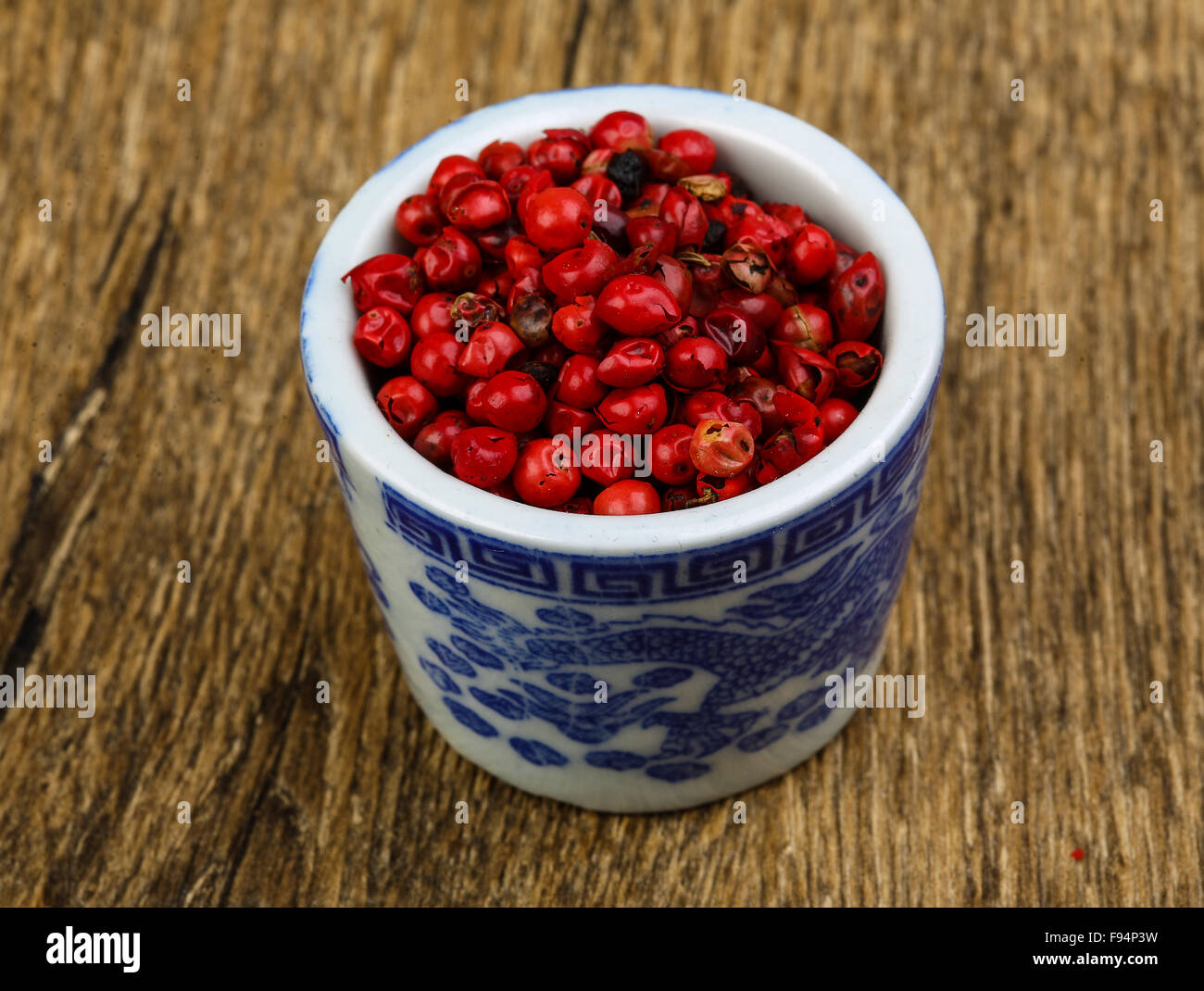 Dry Rose pepper corn on the wood background Stock Photo - Alamy