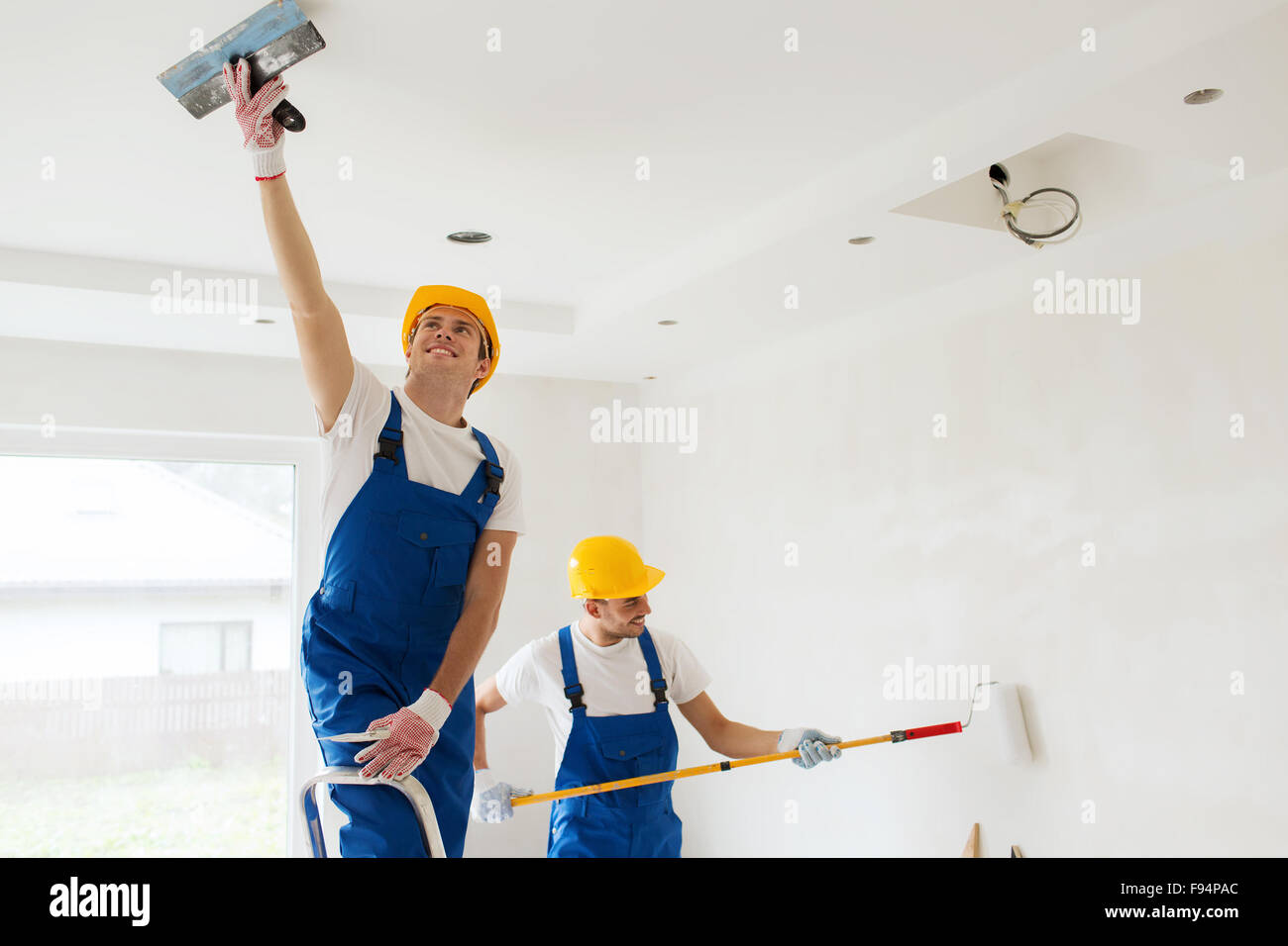 group of builders with tools indoors Stock Photo - Alamy
