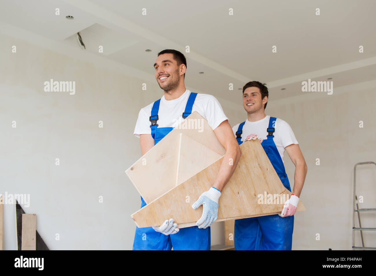group of builders with wooden boards Stock Photo - Alamy