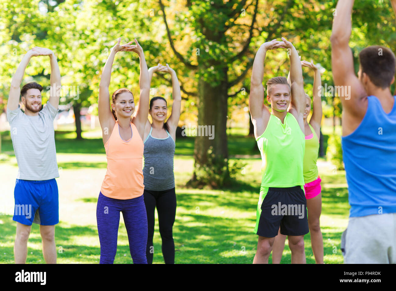 group of friends or sportsmen exercising outdoors Stock Photo - Alamy