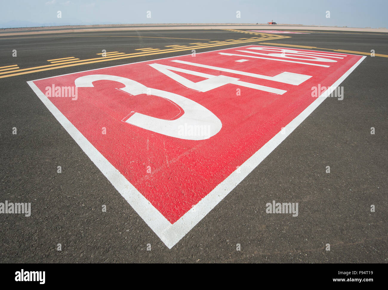 Directional sign markings on the tarmac of runway at a commercial ...